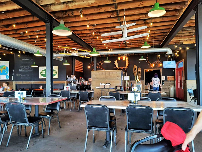 Industrial-chic meets lakeside charm with exposed beams, vintage lighting, and snowshoes that found their winter home on the ceiling.