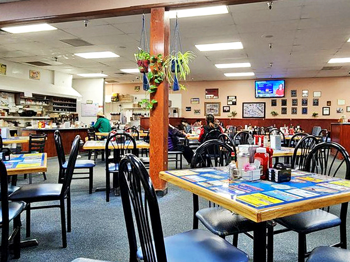 Black chairs, wooden tables, and wall-to-wall charm - this dining room feels like the living room of that friend who always makes extra pancakes.