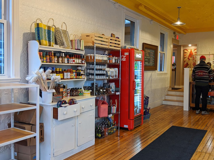 A retro Coca-Cola machine adds a pop of red to this charming market area, where shelves brim with local goodies and culinary treasures. Photo credit: Rebecca Steinberg