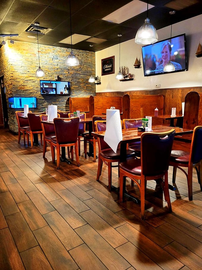 Church pew-style booths and nautical decor create a cozy harbor of comfort, perfect for diving into seafood treasures.
