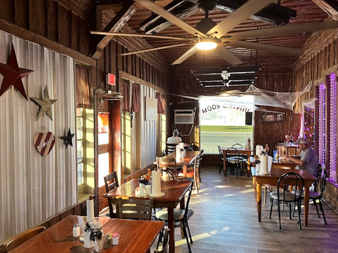 Rustic wooden walls adorned with metal stars create a cozy dining atmosphere where every table feels like the best seat in the house.