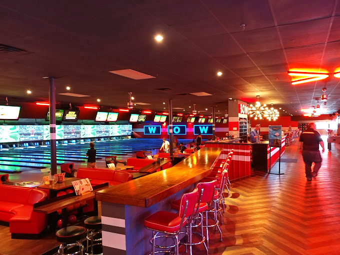 Retro meets modern with glowing lanes and plush red booths creating an atmosphere that's equal parts "Happy Days" and contemporary cool.