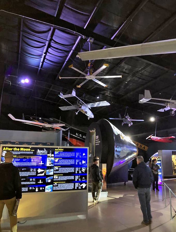 Space-age meets storytelling in this immersive gallery, where aircraft models dance overhead like mechanical ballerinas in a high-tech theater.