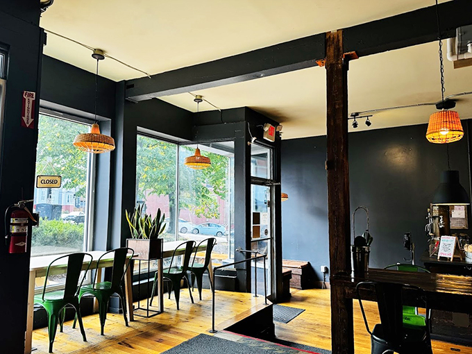 Industrial chic meets cozy comfort with dark walls, warm wooden beams, and those charming basket pendant lights that make everything look Instagram-worthy.