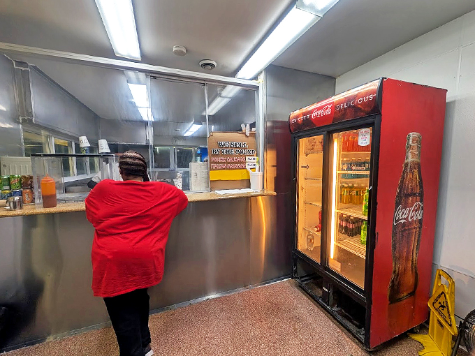 Behind that stainless steel counter, culinary magic happens. The vintage Coca-Cola cooler adds a perfect touch of nostalgia.