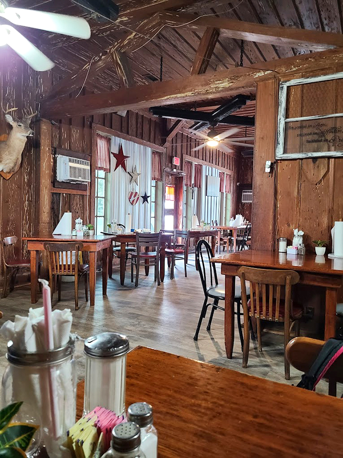 Weathered wood walls adorned with stars tell stories of countless meals shared, while red-checkered curtains add that perfect touch of nostalgia.