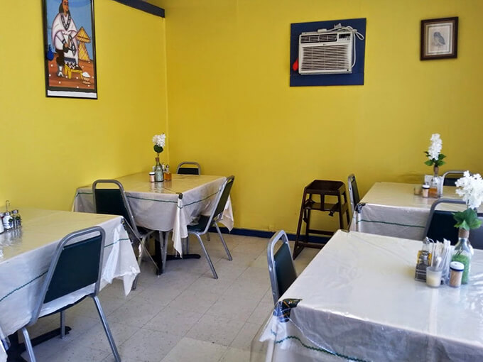 Sunshine-yellow walls and simple tables create an unpretentious charm that feels like dining in someone's home, complete with traditional artwork.