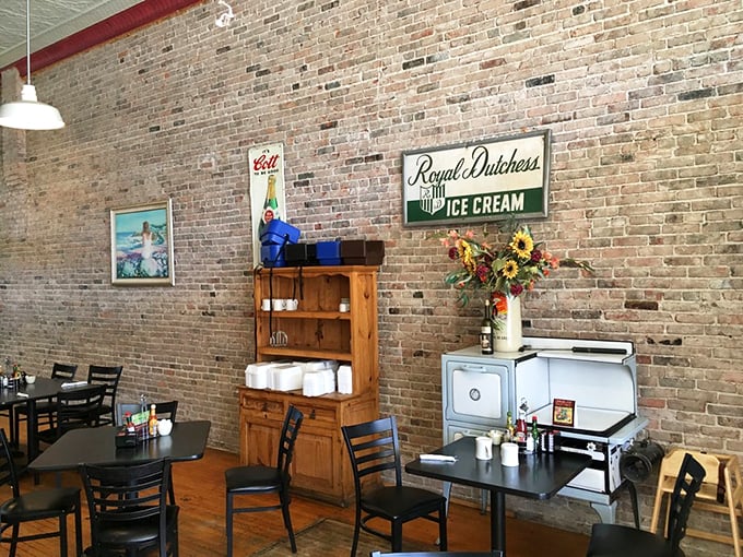 Exposed brick walls and hardwood floors create a warm, inviting atmosphere that feels like stepping into your favorite aunt's dining room.