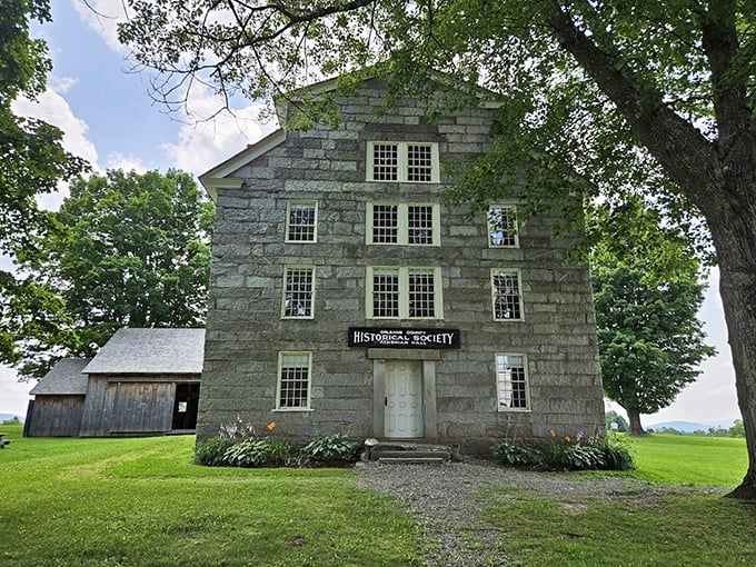 The granite fortress of learning stands proud, its windows like watchful eyes gazing over two centuries of Vermont history.