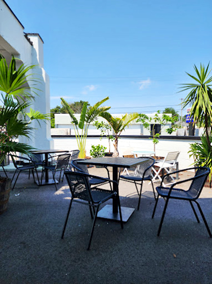 Palm-fringed tables create an oasis where morning coffee meets Florida sunshine&mdash;nature's perfect breakfast companion. 