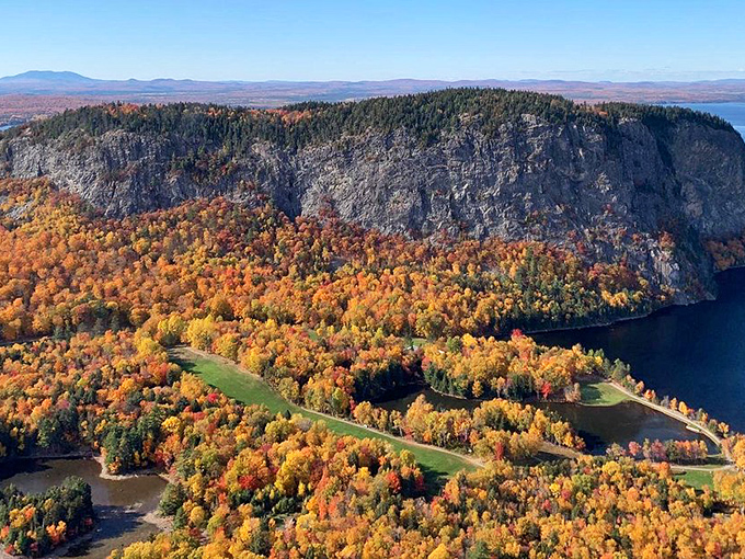 Mount Kineo's dramatic cliffs rise like Maine's answer to Gibraltar, creating a stunning backdrop for fall foliage that would make Bob Ross weep.