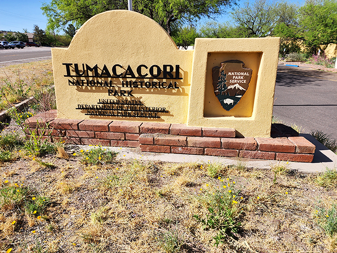 Welcome to Tumacacori, where history and cacti collide! This sign's got more personality than a saguaro in a sombrero.