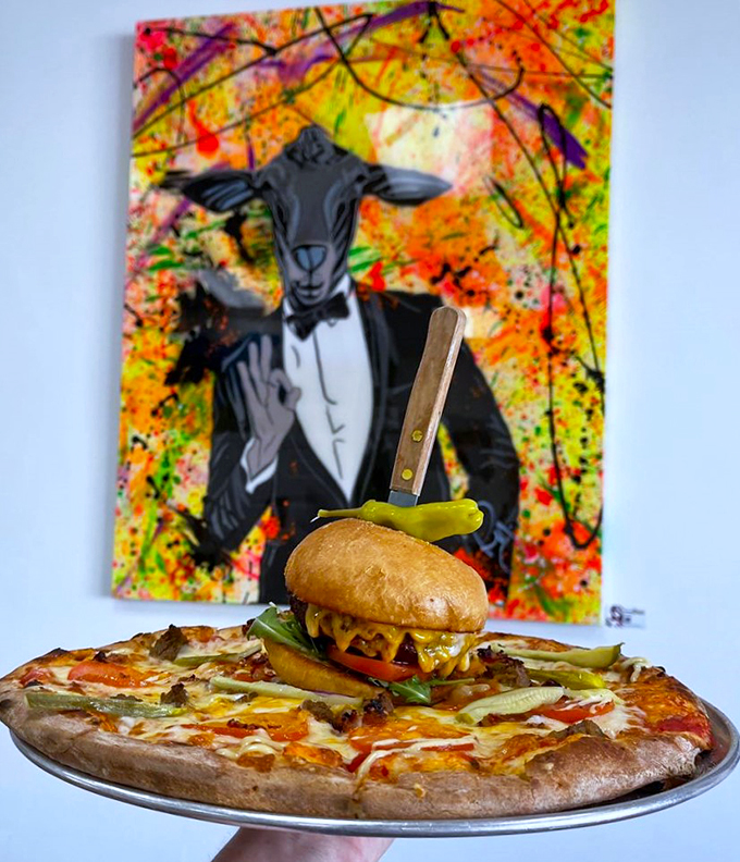 Art meets appetite with this masterful presentation&mdash;a gourmet burger perched proudly against a backdrop of vibrant sheep-themed artwork.