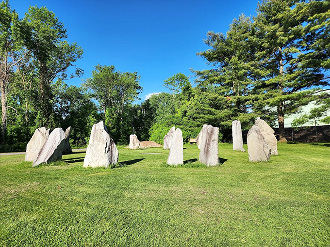 Nature's own sundial: Massive granite stones cast their shadows across perfectly manicured grass, marking time in the most dramatic way.