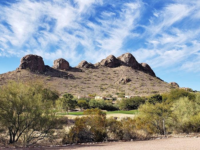 Rocky sentinels guard this golfing oasis. The clubhouse nestles at the foot of nature's skyscrapers, promising adventure with every swing.