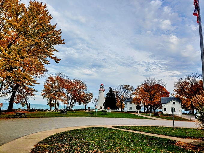 Fall's fiery palette frames this lakeside sentinel. Who knew Ohio could rival New England for autumn splendor?
