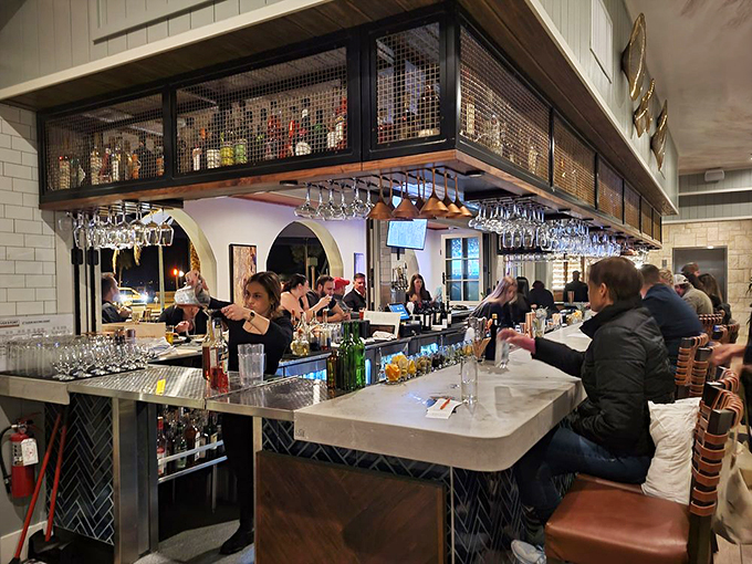 Bottoms up, folks! This bustling bar scene is where liquid magic happens. Mixologists shake, stir, and pour your next favorite cocktail. Photo credit: Jessica P. 