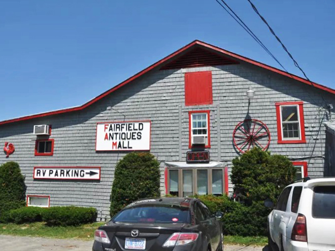 Behold the portal to yesteryear! With its cheery red trim and wagon wheel greeter, this place screams "Come in, the past is waiting!"
