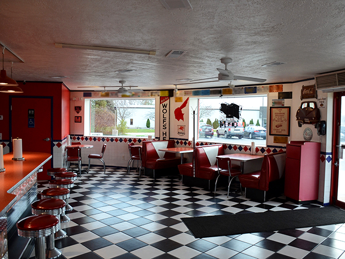 Step into a time warp! Wayne's interior is a checkerboard dream, where red vinyl booths shine brighter than a freshly waxed '57 Chevy.