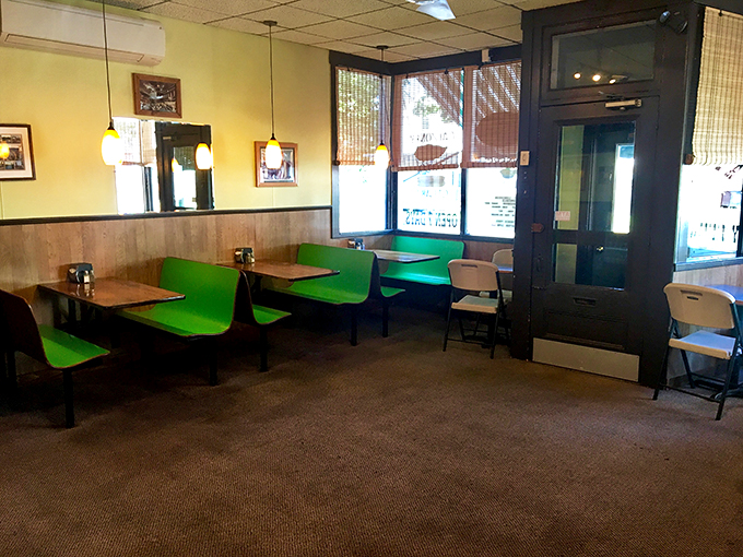 Step into a time capsule of cozy nostalgia. These vibrant green booths are like old friends, ready to cradle you while you feast.