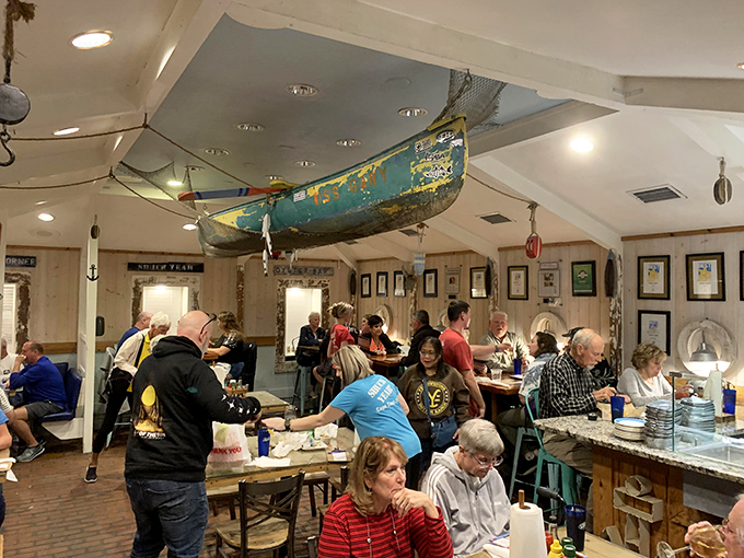 Ahoy, matey! Step into a nautical wonderland where a weathered boat hangs from the ceiling, setting the stage for your maritime feast.