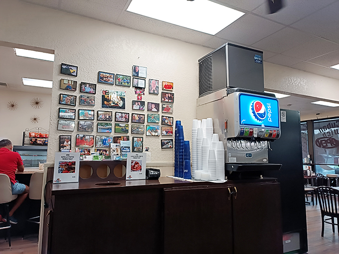 A wall of memories and happy customers. This photo collage is like a greatest hits album of Cafe Caribe's delicious journey - no autographs necessary! Photo credit: Ernesto Roubert
