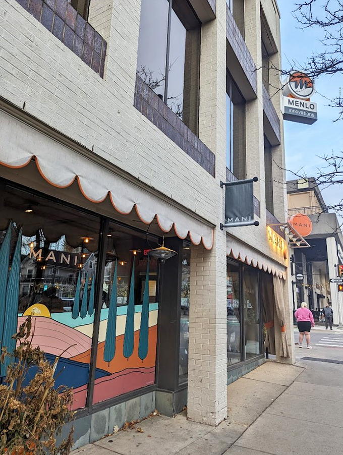 Mani's street presence is as inviting as a warm Italian nonna. That colorful mural? It's not just art, it's a preview of the flavor explosion waiting inside.