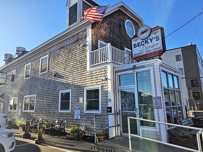 Ahoy, flavor seekers! Becky's Diner's weathered shingles and waving flag beckon like a lighthouse for the hungry. Seafood so fresh, it might swim off your plate!
