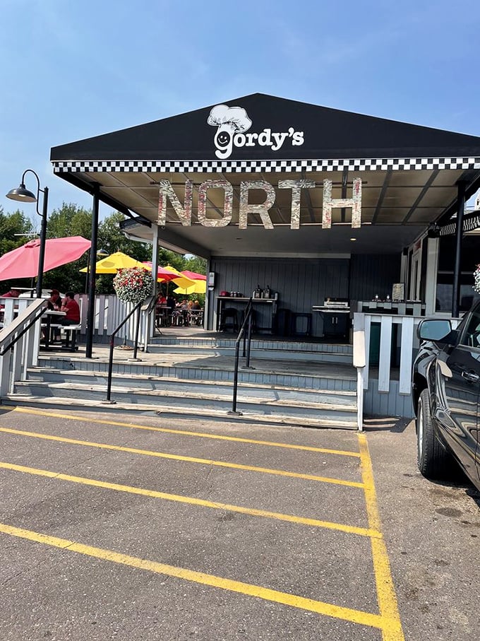 Step into a time machine of taste! Gordy's neon sign beckons you to a world where burgers reign supreme. Photo credit: Scott K.