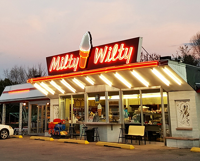 Neon dreams come true! Milty Wilty's sign blazes like a beacon of hope for hungry souls, promising frosty delights and nostalgic nights.