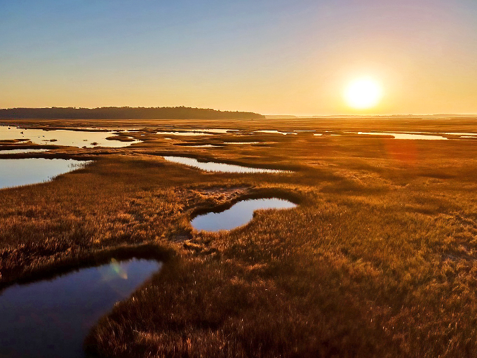 Scarboro Marshes: Nature's golden hour party! This sunset transforms the marsh into a shimmering sea of amber waves. Who needs a red carpet when you've got this?