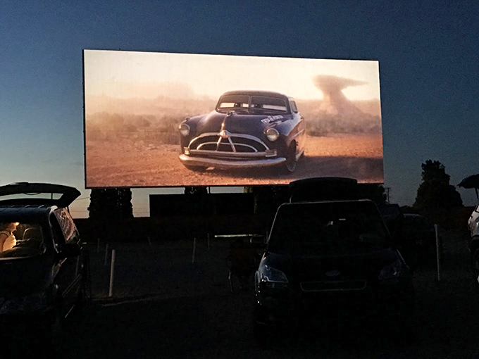 Movie magic meets twilight charm. As the sun sets, the screen awakens, transforming your car into the best seat in the house. Photo credit: Allen Summerer