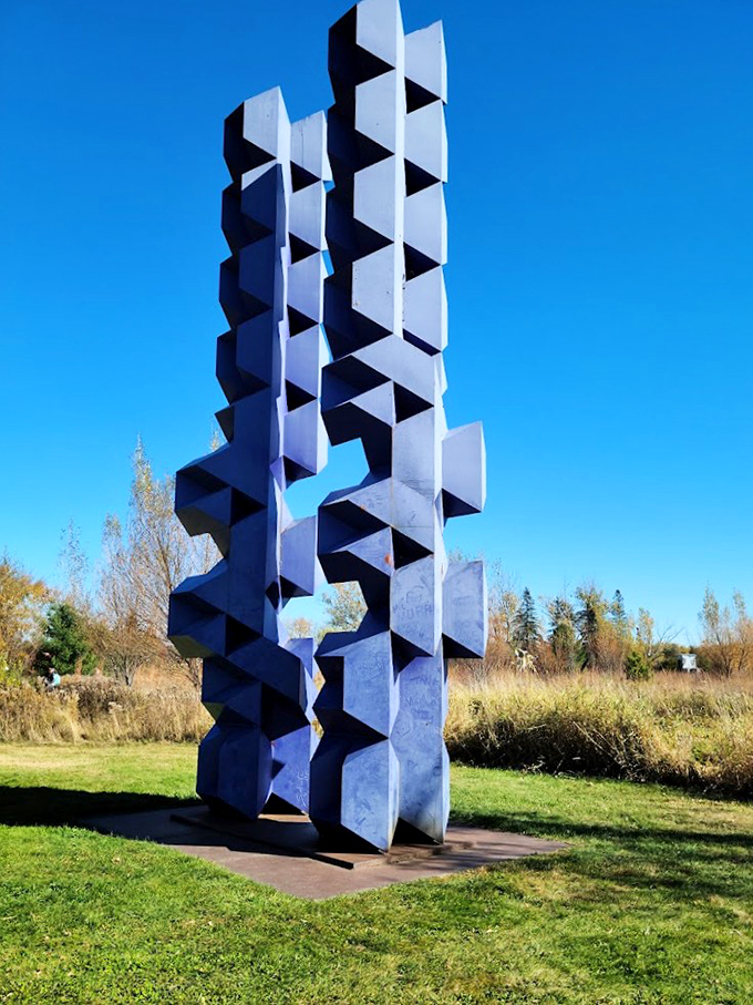 Abstract geometry gone wild! This blue behemoth looks like it escaped from a Picasso painting and decided to hang out in the Minnesota countryside.