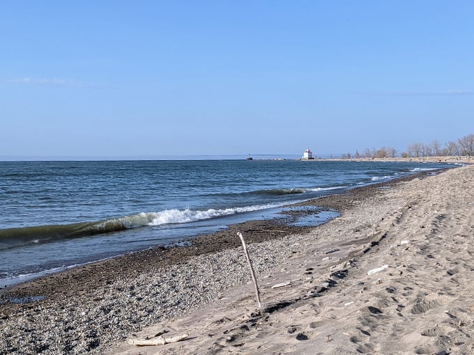 Waves lap gently at Ohio's longest natural beach. A perfect canvas for sandcastle architects and sunbathing enthusiasts alike. Photo credit: P P-W