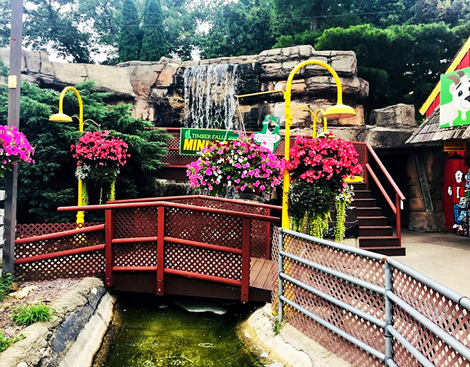 Hanging flower baskets and winding wooden bridges transform this mini-golf paradise into a picture-perfect summer escape.