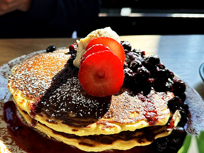 Fluffy clouds of joy: These pancakes are so light, they might float away if not anchored by a river of berry compote.