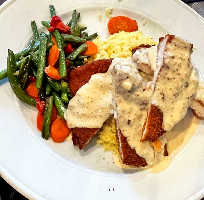 Their signature almond chicken arrives like a work of art, with perfectly steamed vegetables adding pops of color to this comfort classic.