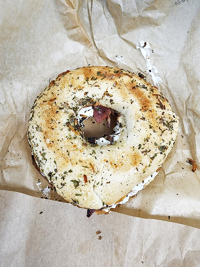 This herb-crusted bagel with cream cheese isn't just breakfast - it's your morning's main character in a delicious story.