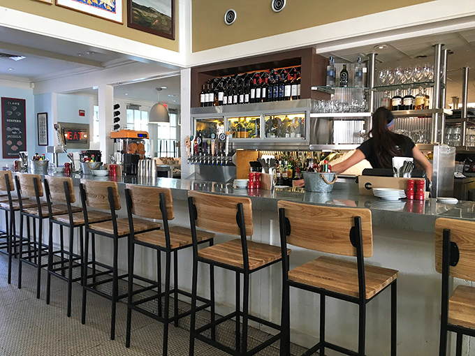 The bar area strikes that perfect balance between upscale and cozy, with wooden barstools that invite you to stay awhile.