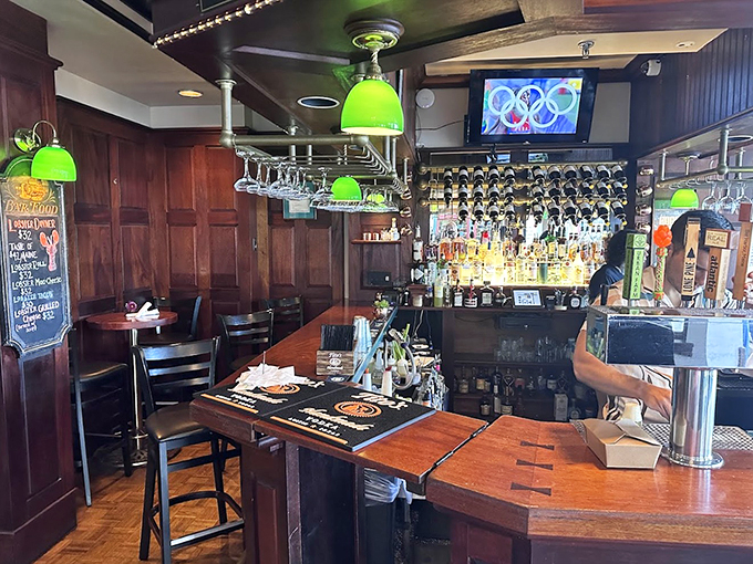 The bar glows with green pendant lights, while an impressive array of spirits stands ready for your evening's adventure. 