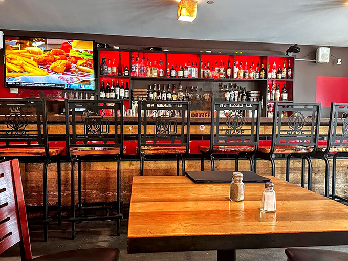 The well-stocked bar beckons with its impressive selection, backed by a striking red wall that adds drama to every sip.