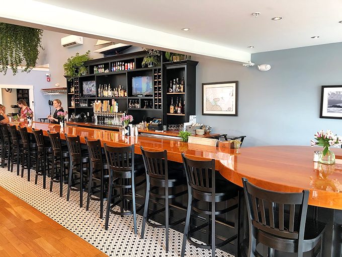 The gleaming copper bar top and well-stocked shelves create an inviting space that feels like the living room of your seafaring dreams. Photo credit: Brent Toliver