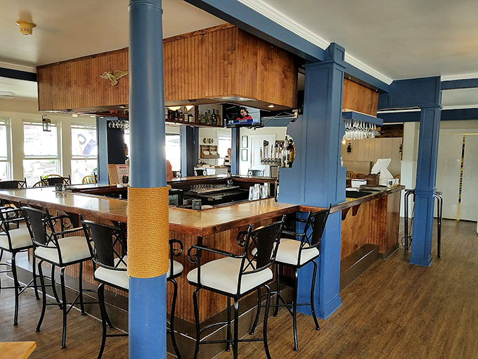 Navy blue pillars and rope-wrapped columns give this nautical bar the perfect blend of maritime charm and modern comfort.
