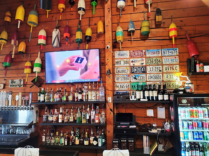 Where vintage license plates meet colorful buoys - this bar wall tells more stories than your favorite uncle at Thanksgiving.