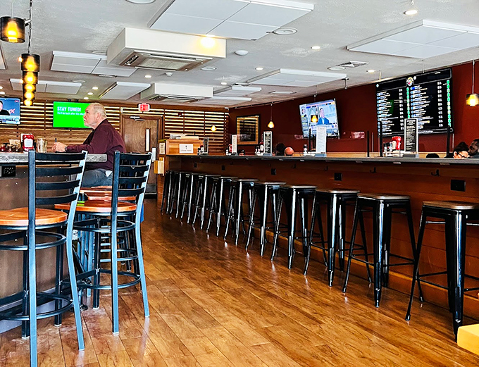 The inviting bar area offers a cozy retreat where friendly faces gather over cold brews and hot conversations. Photo credit: Chiranjib Misra