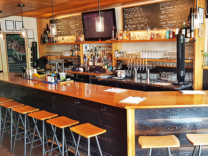 Behold, the altar of libations! This bar is stocked better than my grandmother's pantry during Y2K. Craft beers flow like rivers and cocktails are mixed with the precision of a Swiss watchmaker.
