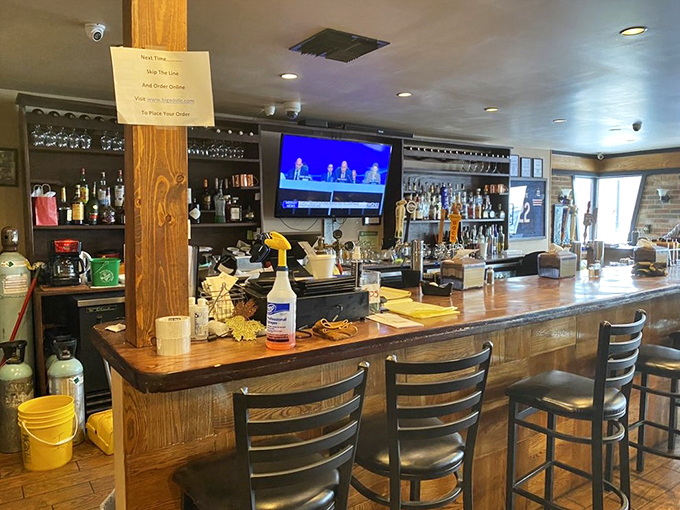 A proper BBQ joint's bar, where sports meet spirits, and the wooden bar top tells stories of countless satisfied customers.