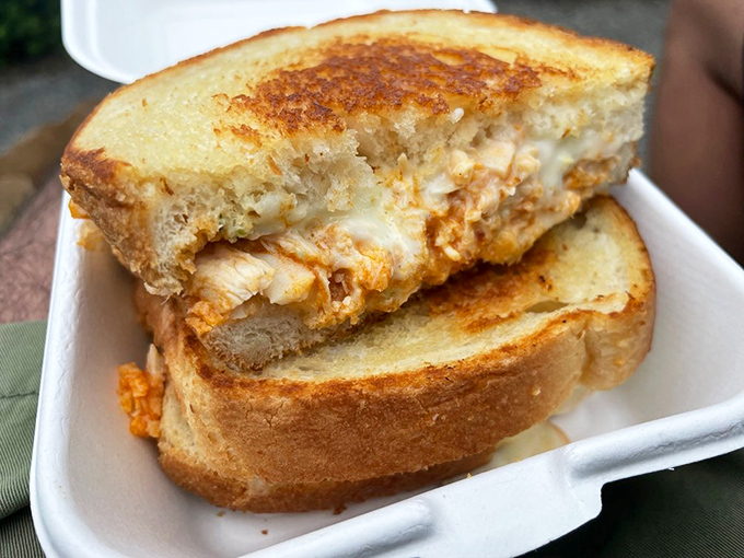 Golden-grilled sourdough cradles perfectly sauced buffalo chicken in this masterpiece of comfort food engineering.