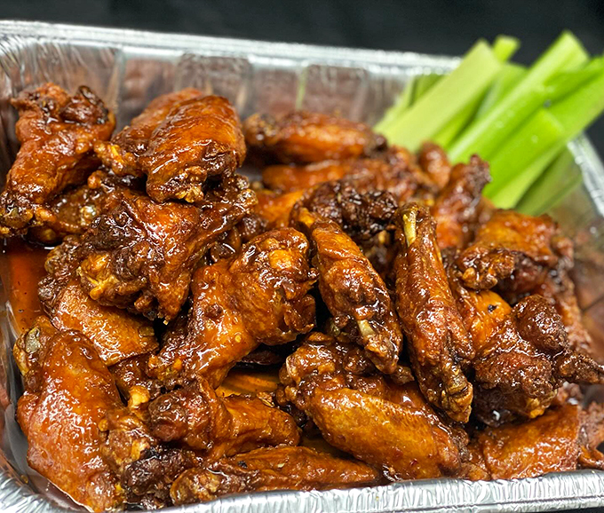 These buffalo wings aren't just crispy, they're a masterclass in sauce-to-meat ratio perfection, glistening with tangy promise.