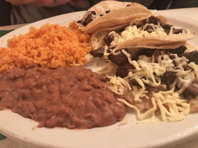 Simple perfection on a plate: tender carne asada tacos with all the fixings, plus rice and beans that taste like abuela's kitchen.
